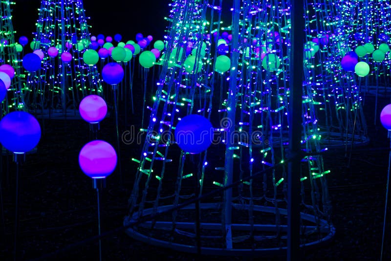 Blue and Pink Bulbs of Light Rising through Towers - Modern Light Show ...