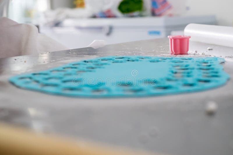 A Blue and Pink Cake Pan Sits on a Counter with a Pink Icing Tip Clay ...
