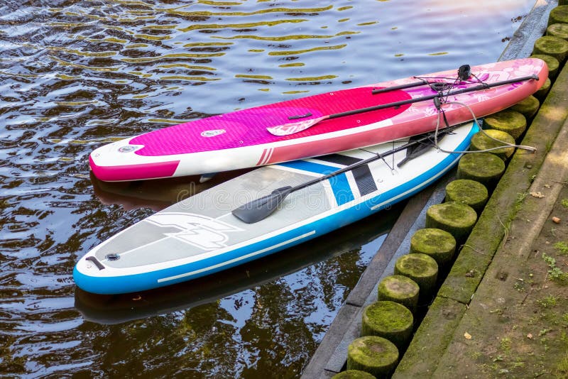 Blue and Pink Paddle Boards in the Canal Stock Photo - Image of boating ...