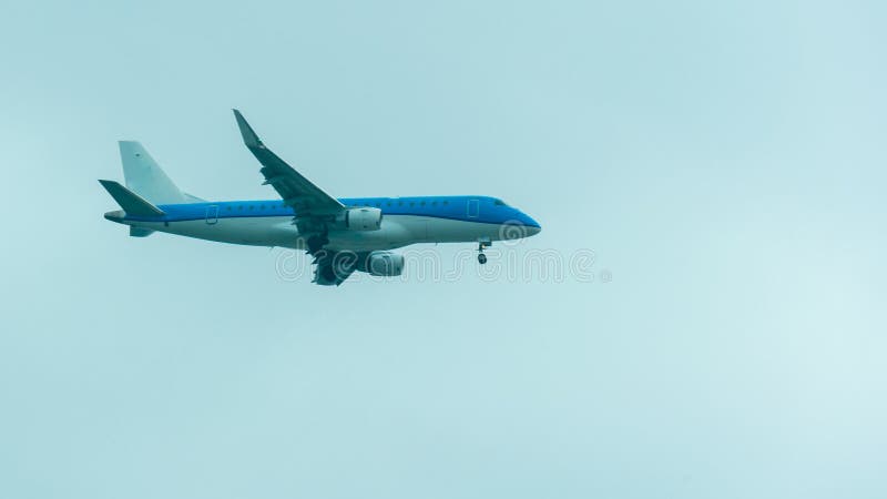 A Blue Plane Flying and Preparing To Land, with the Open Landing Train ...