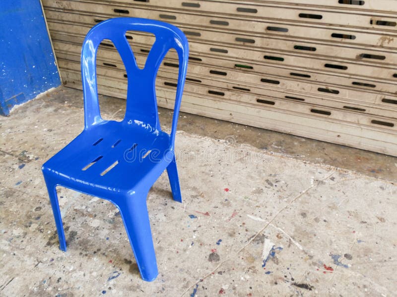 Blue Plastic Chair on Cobbled Pavement Stock Photo - Image of brown ...