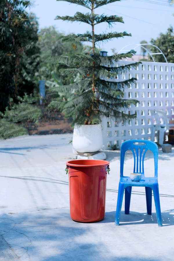 Blue Plastic Chairs and Red Plastic Water Buckets are Placed Outdoors ...