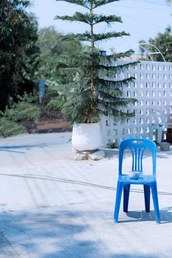 Blue Plastic Chairs and Red Plastic Water Buckets are Placed Outdoors ...