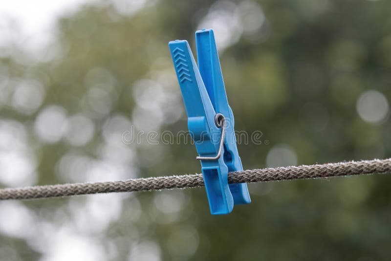 Blue Plastic Clothespin on a Clothesline Stock Image - Image of wood ...
