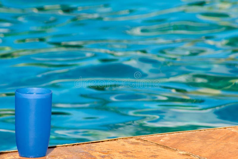 Blue Plastic Cup on the Edge of a Swimming Pool Stock Image - Image of ...