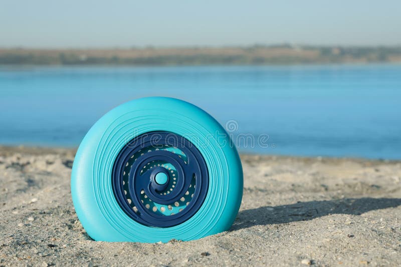 Blue Plastic Frisbee Disc on Sandy Beach Near River Stock Photo - Image ...