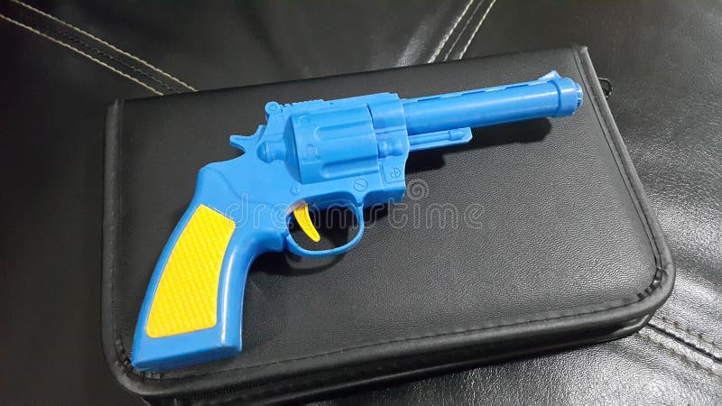 Blue Plastic Gun a Yellow Handle and Trigger is Placed Stock Photo ...