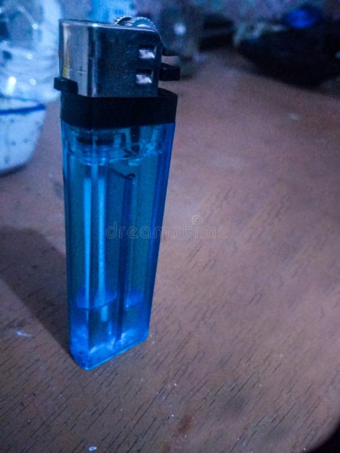 Blue Plastic Lighters on Table Wood Stock Photo - Image of table ...