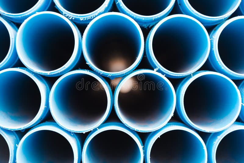 Blue Plastic Pipes Stacked in Rows. Look Inside the Pipe. Background ...