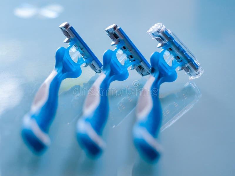Blue Plastic Razors on the Shiny Mirror Stock Image - Image of grooming ...
