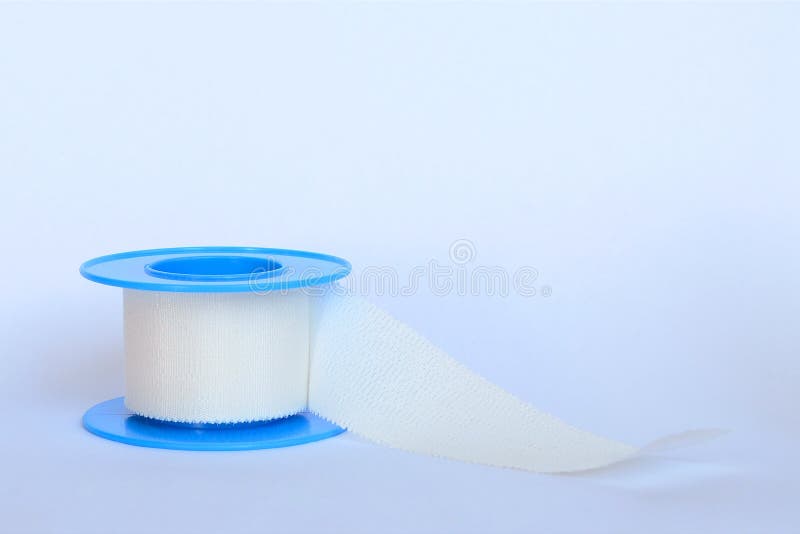 Blue Plastic Roll with White Textile Medical Plaster on a Neutral ...