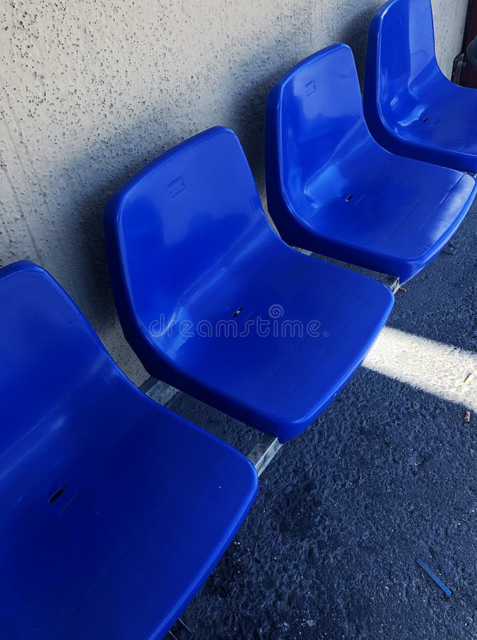 Blue plastic seats stock image. Image of blue, wall - 102885617