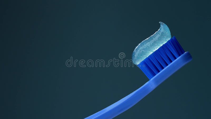 Blue Plastic Toothbrush with Toothpaste on a Blue Background. the ...