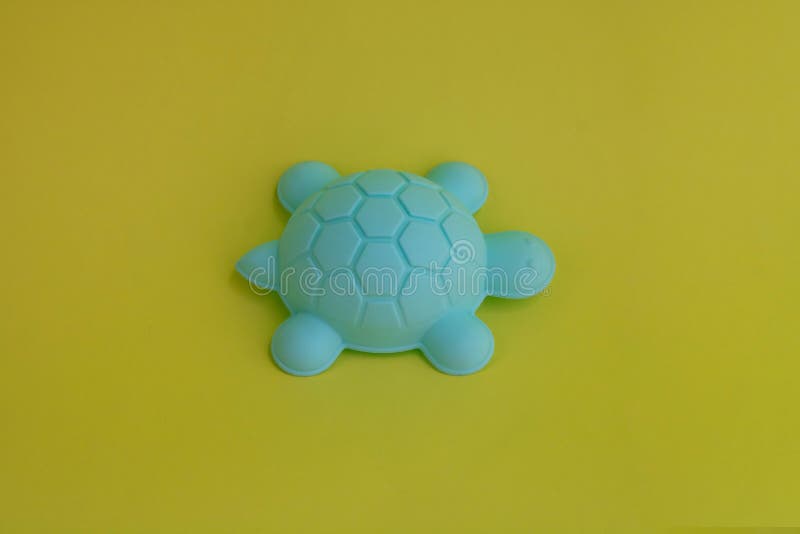 A Blue Plastic Turtle Toy, Isolated on a Yellow Background Stock Photo ...