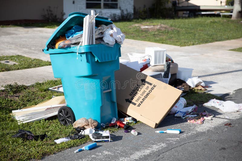 Blue Plastic Waste Bin Surrounded by Overflowing Trash on the Side of a ...