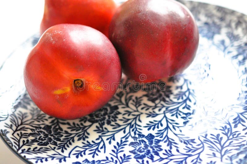Blue plate with nectarines stock photo. Image of plant - 332402114