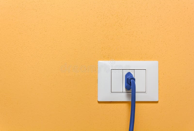 Blue Plug in a Wall Socket on an Orange Wall Stock Photo - Image of ...