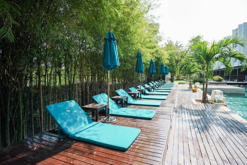 Blue Pool Chairs on Wooden Floor in Luxury Hotel Stock Photo - Image of ...