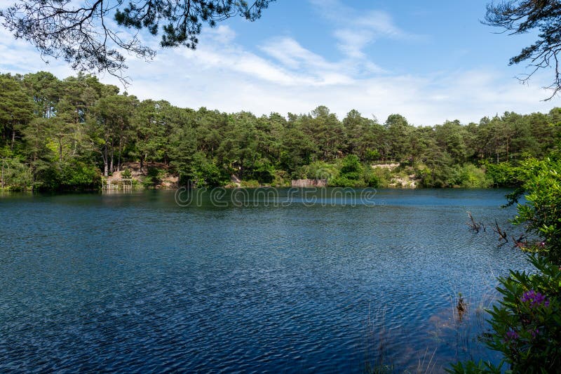 Blue pool in Dorset stock image. Image of landmark, forest - 346709259