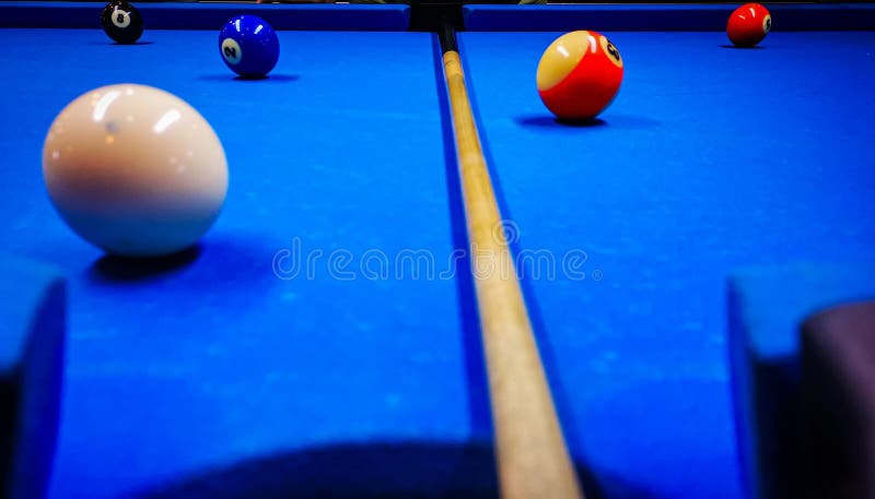 Blue Pool Table with Multiple Balls and Pool Cue on the Table Stock ...