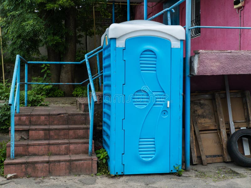 Blue Portable Toilet Standing on the Side of the Building Stock Photo ...