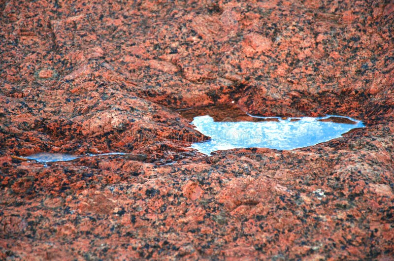 Blue Puddle on the Red Stone. Stock Image - Image of spotted, brown ...