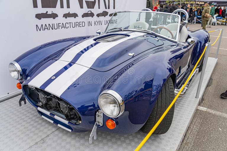 A Blue Racing Car with White Stripes is Displayed on a Platform, Posed ...