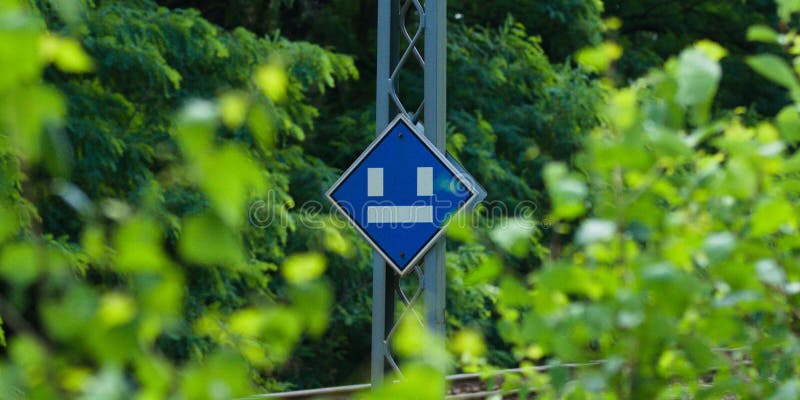 Blue Railway Sign Surrounded by the Bushes Stock Image - Image of blue ...