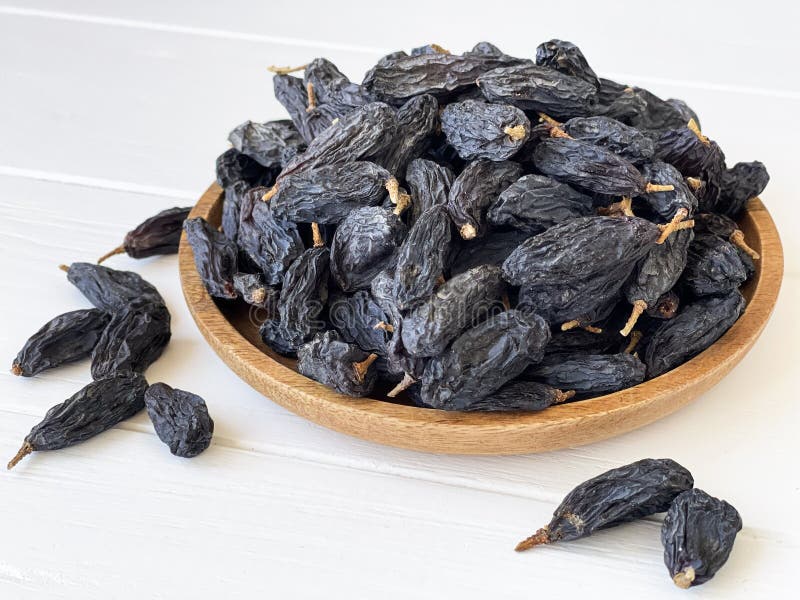 Blue raisins on a plate stock photo. Image of vegetarian - 216821438