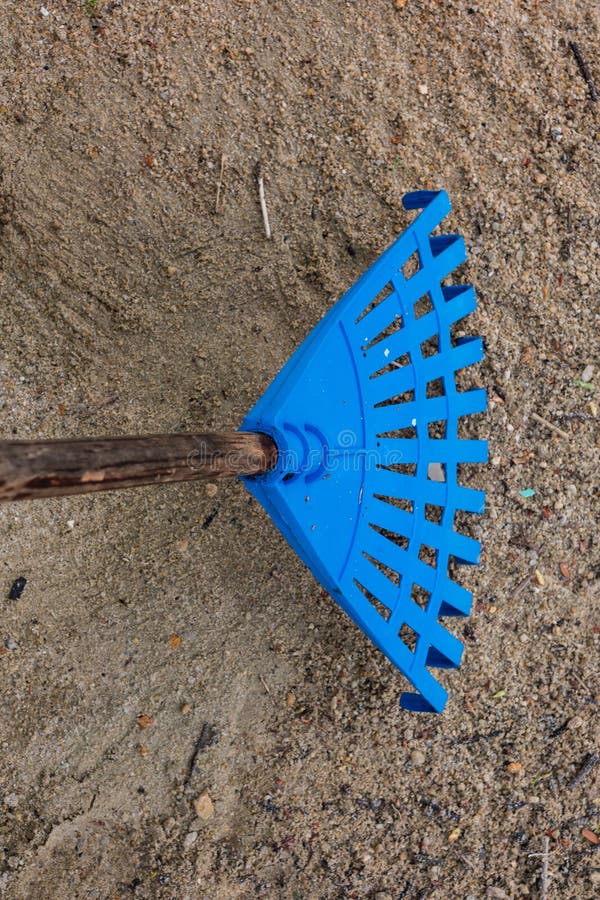 Blue Rake Over Yellow Dried Leaves Stock Photo - Image of rake, ground ...