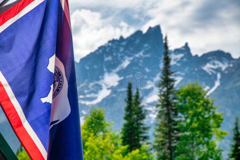 Blue and Red Flag in Yellowstone National Park Surrounded by Trees and ...