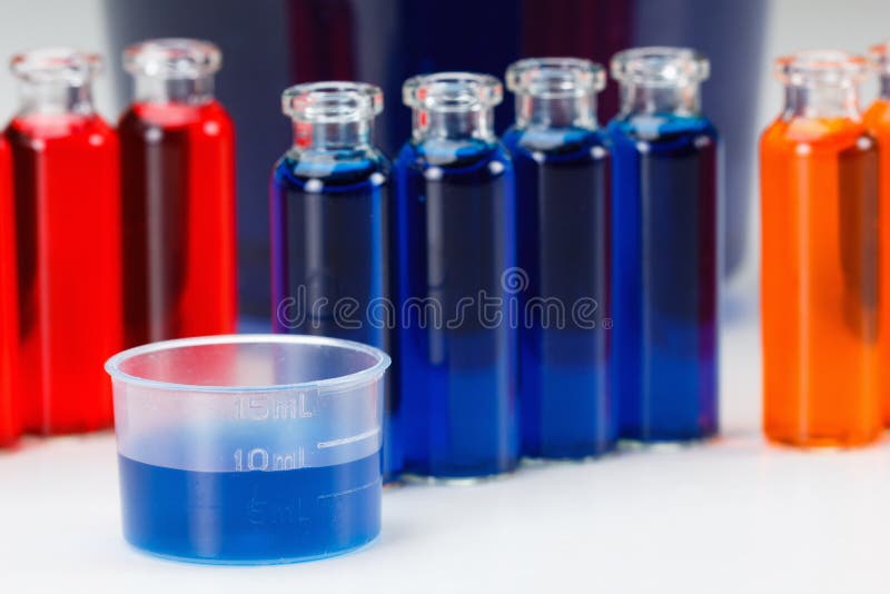Blue, Red and Orange Liquid in Chemical Lab Test Tubes on White ...