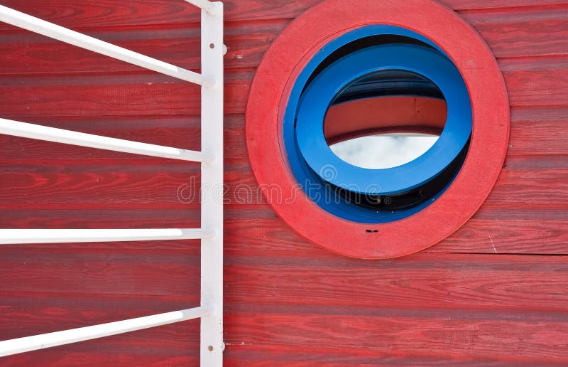 Blue and Red Round Window in a Red Wooden Wall Stock Image - Image of ...