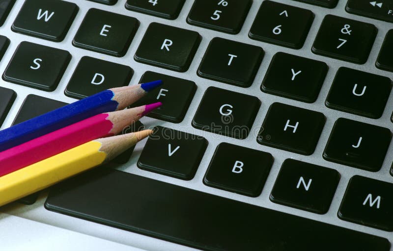 Blue, Red and Yellow Drawing Pencils on the Keyboard Stock Photo ...