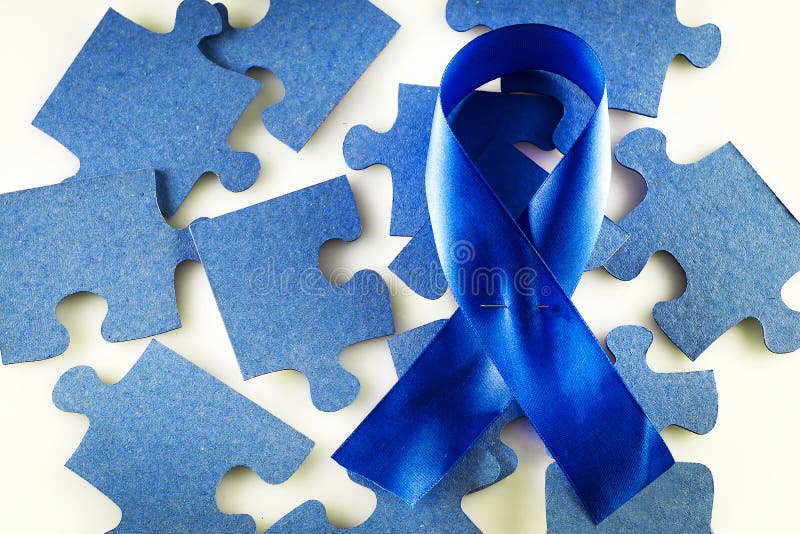 A Blue Ribbon on a Background of Scattered Jigsaw Puzzles Stock Image ...