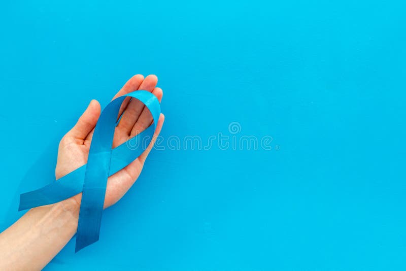 Blue Ribbon in Hands As Symbol Disease Control on Blue Background Top ...