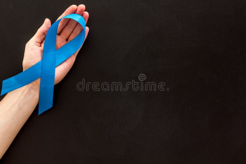 Blue Ribbon in Hands As Symbol Disease Control on Black Background Top ...