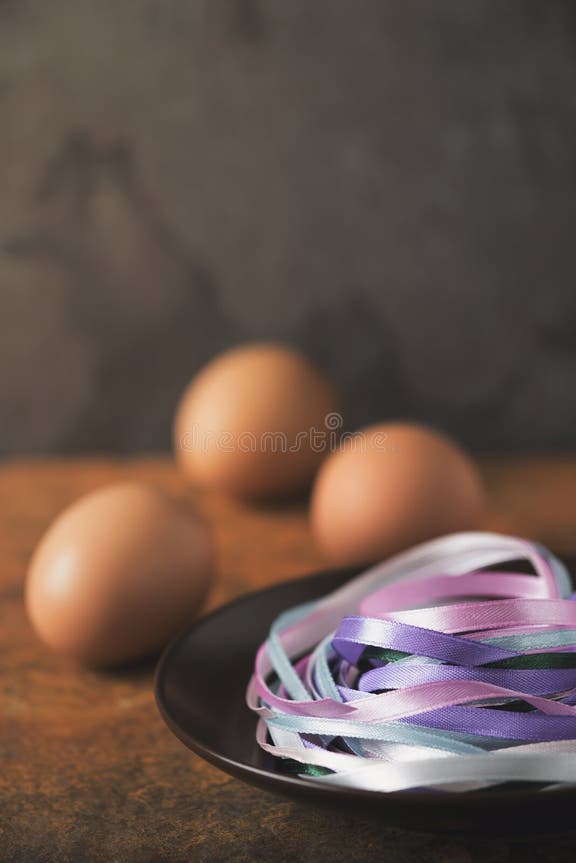 Blue Ribbons in the Plate with Blurred Eggs Vertical Stock Photo ...