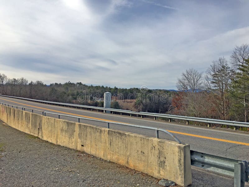 Blue Ridge Dam View of Tree Line and Highway Divider Wall Stock Image ...