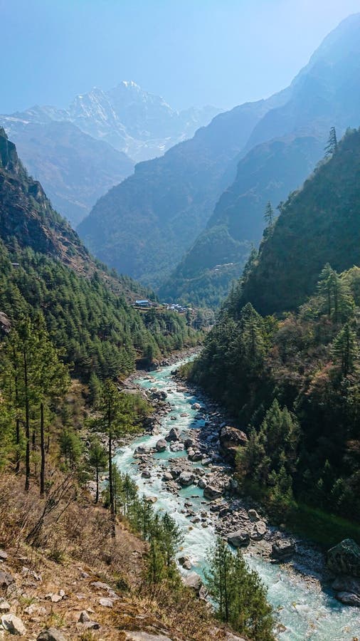 Blue River Running in the Valley, Overlooking Majestic Mountains Stock ...