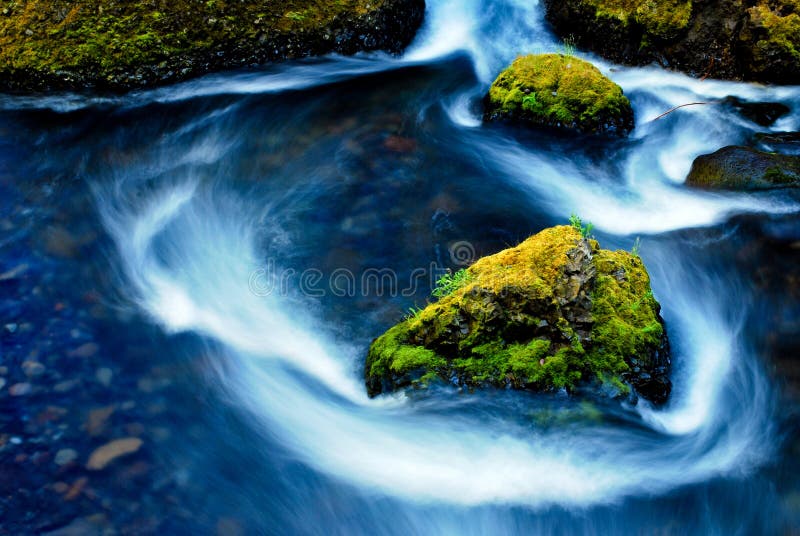 Blue River Water Rushing by Green Moss Covered Rocks Stock Image ...
