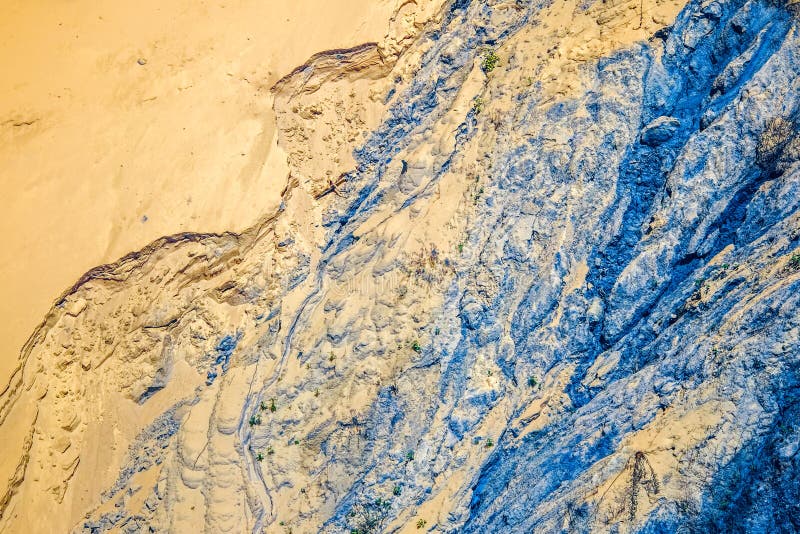 Rivulets in Sand Along Side Rock Formation Covered with Marine Plants ...
