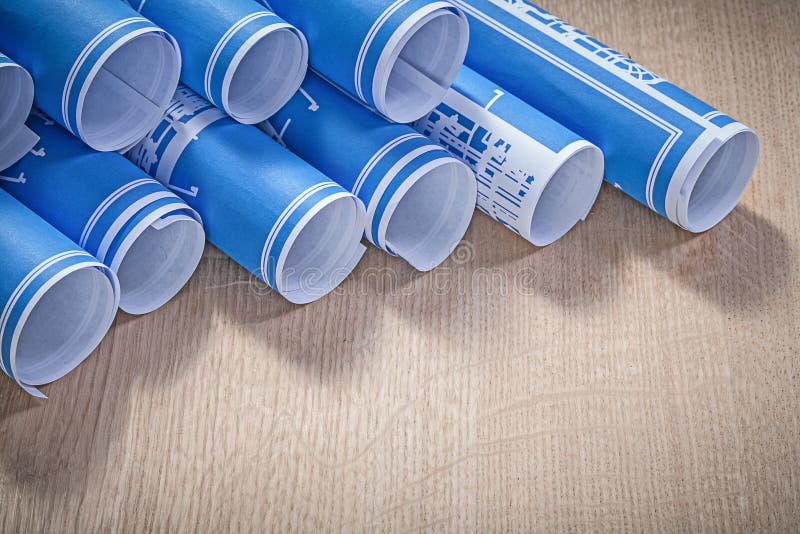 Blue Rolled Up Construction Drawings on Wood Board Top View Main Stock ...