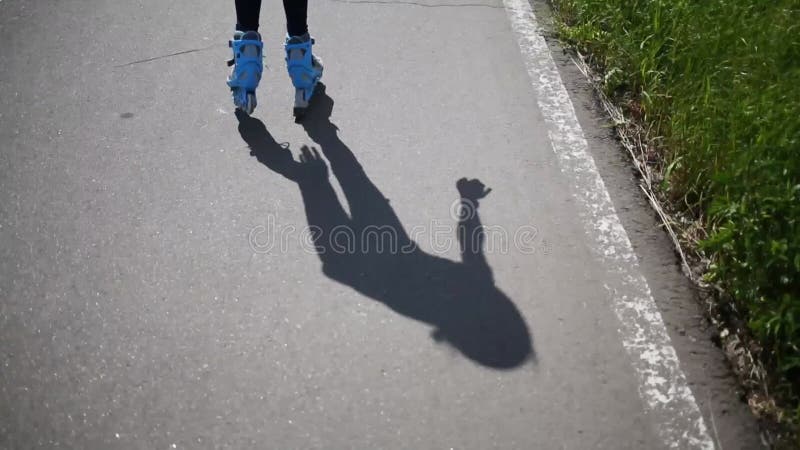 Blue Rollers on Legs and Shadow of Girl on Stock Footage - Video of real, pursuit: 324004020