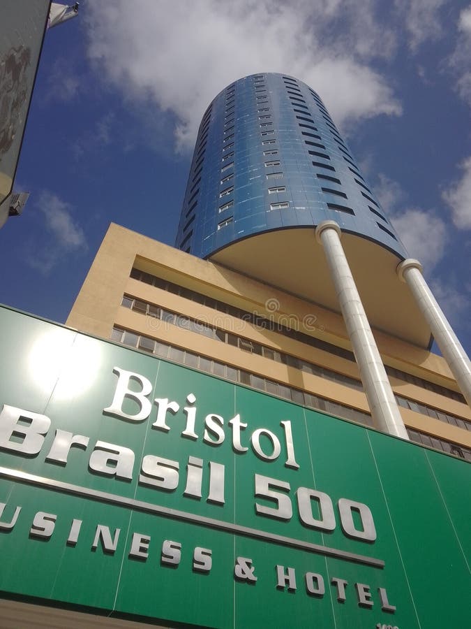 Blue Round Building with Two Columns. Below Beige Rectangular Building ...