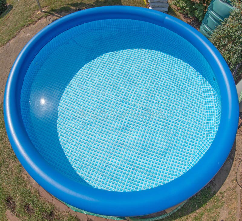 A Round Pool In The Courtyard With Deck Chairs Stock Image - Image of ...