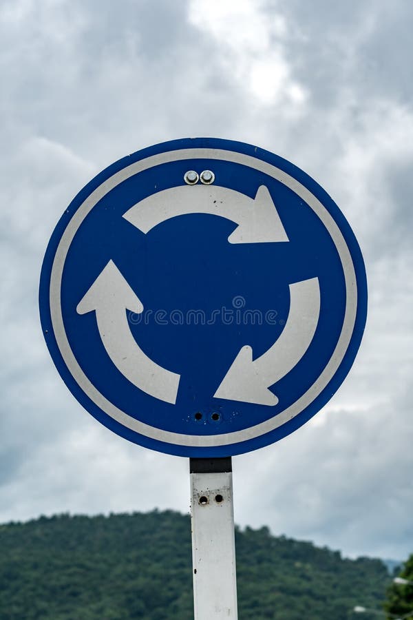 Blue Roundabout Traffic Sign Stock Image - Image of object, white: 80597669