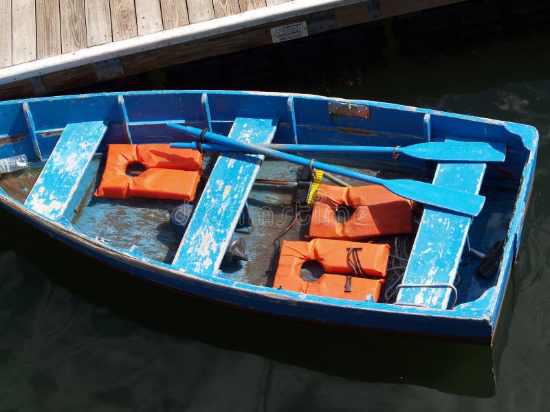 Blue Row Boat with Orange Life Vests at Dock Stock Photo - Image of ...
