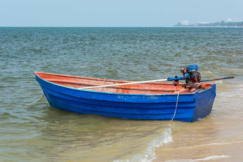 Blue rowboat on the beach stock photo. Image of transport - 67047202
