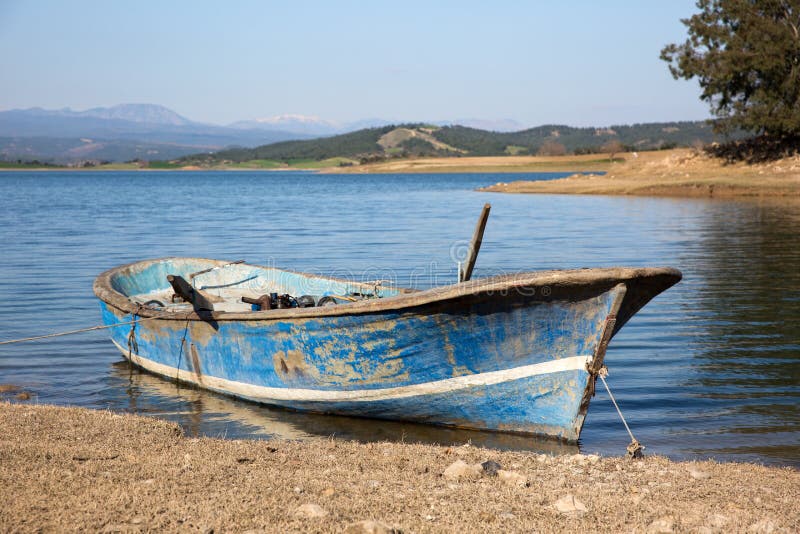 Blue rowing boat on lake stock photo. Image of lonely - 154165904